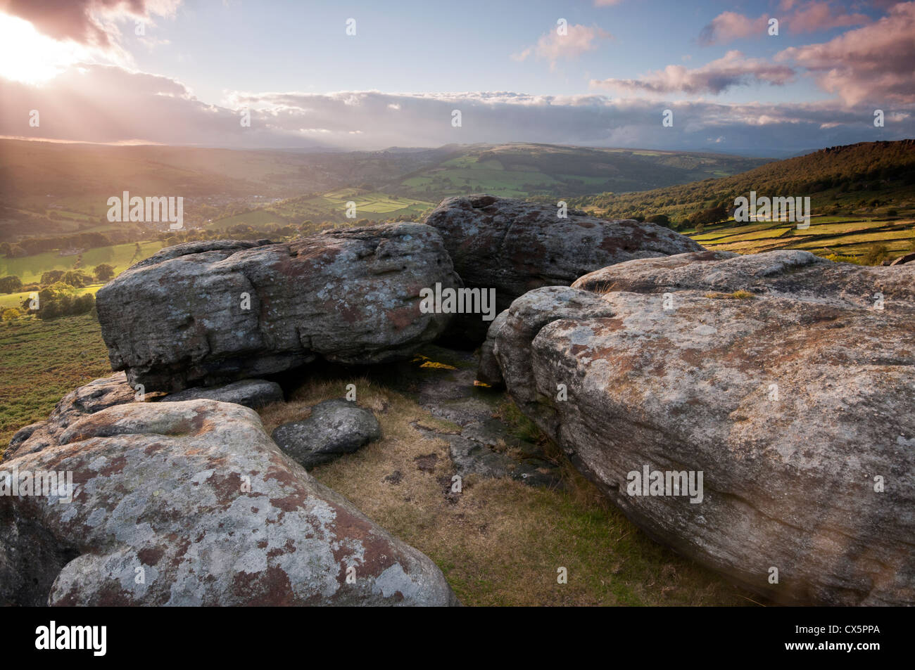 Early autumnal light is cast over rocks on Baslow Edge in Peak District ...