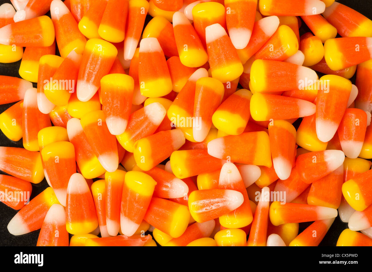 Candy corn sweets as background Stock Photo - Alamy