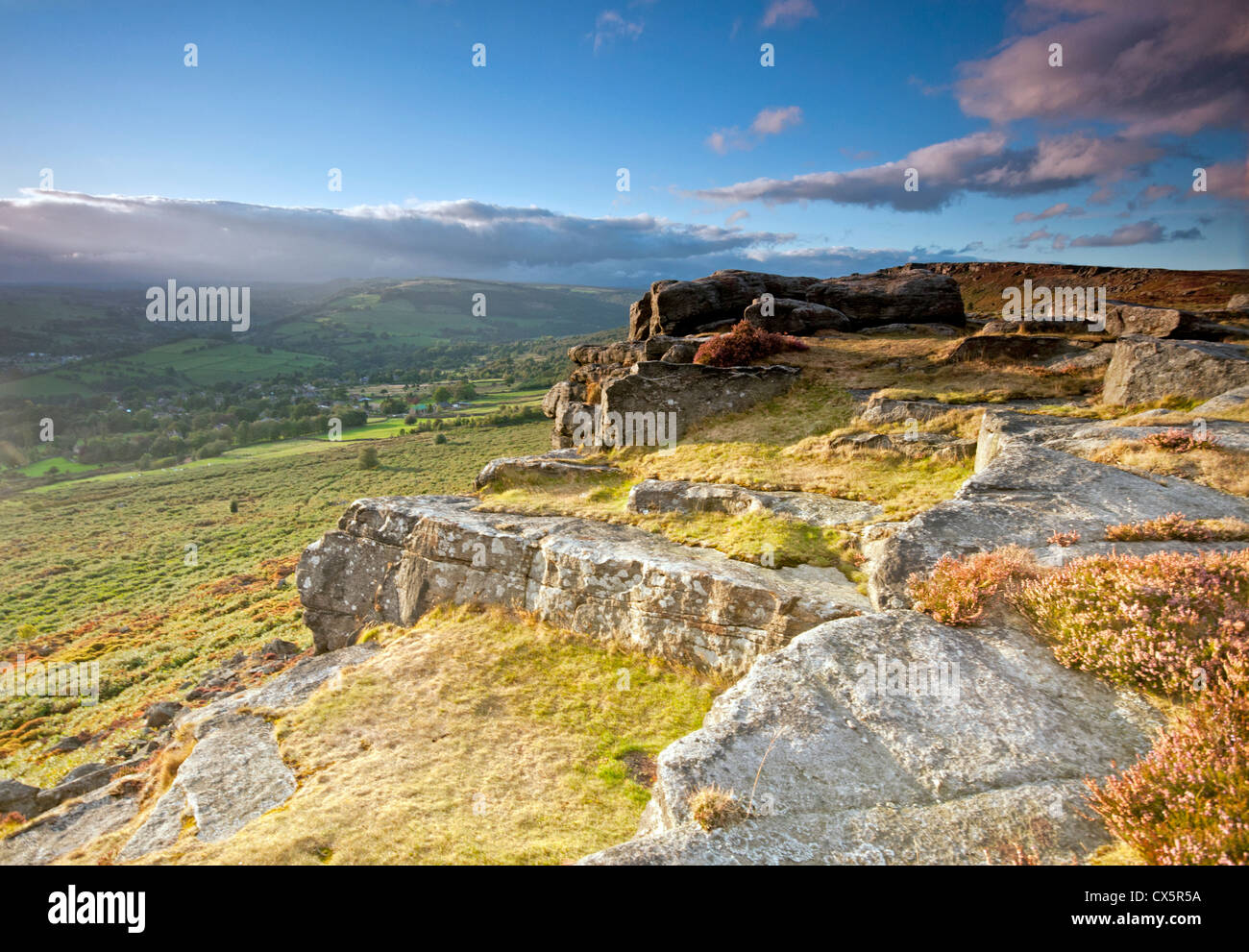 Early autumnal light is cast over rocks on Baslow Edge in Peak District ...