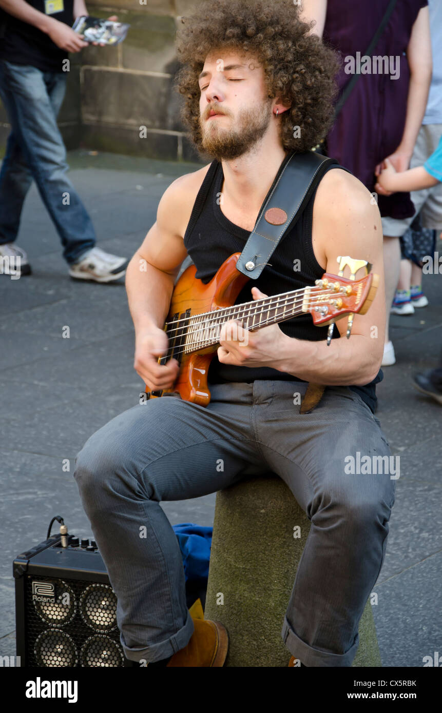 Bass guitarist busking in the Royal Mile, Edinburgh, Scotland, during ...