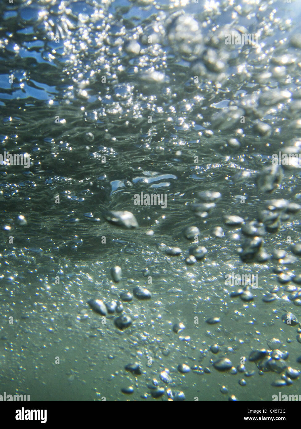 Bubbles made by a wave from below Stock Photo - Alamy