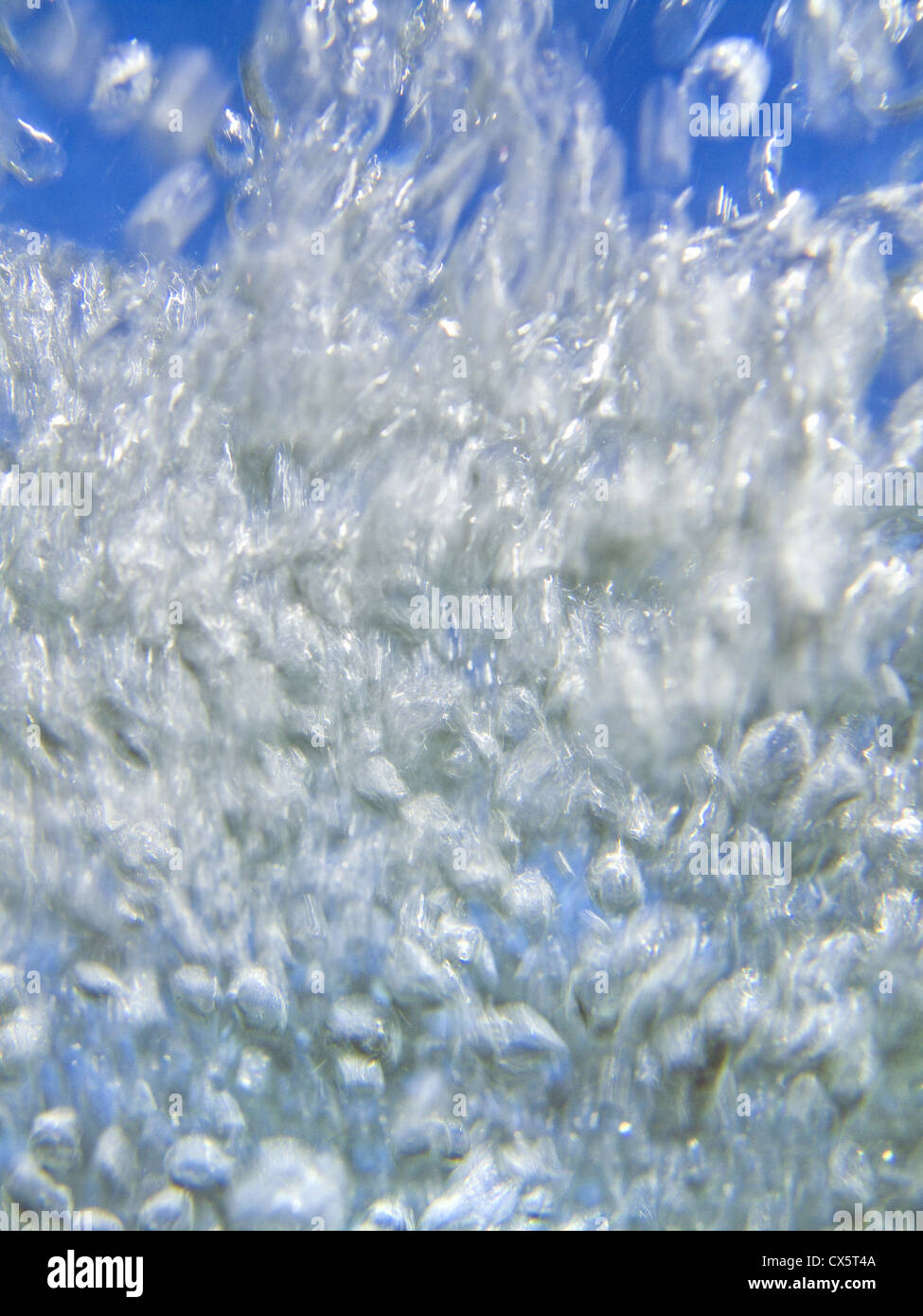 Bubbles made by a wave from below Stock Photo - Alamy