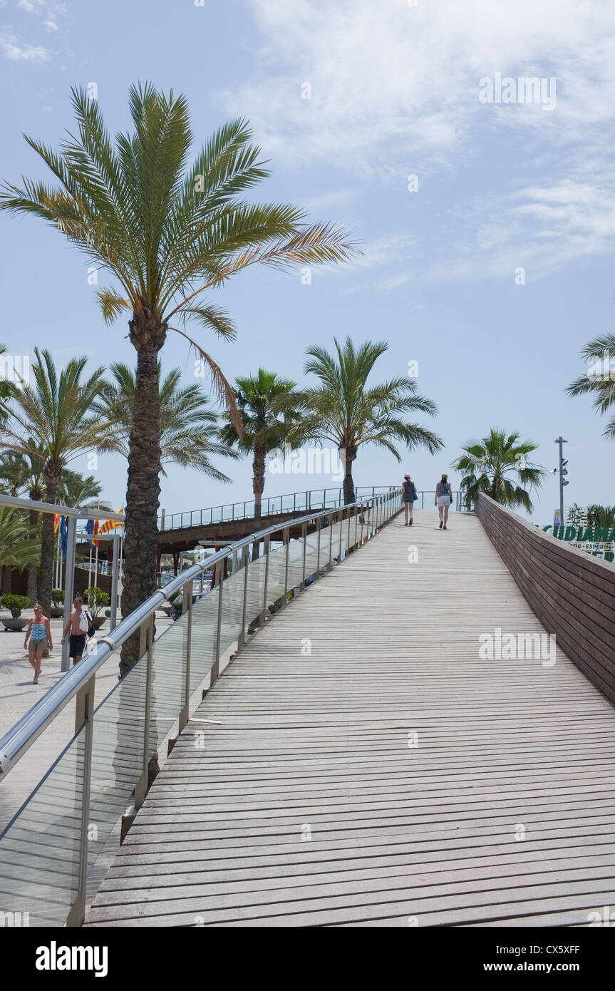 Tourist enjoying the Walkway bridge at Port d Alcudia Mallorca Stock ...