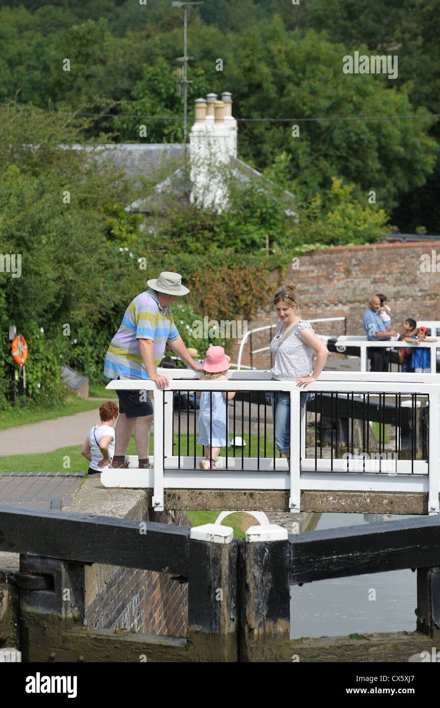 A family standing on one of the small bridges that cross foxton locks ...