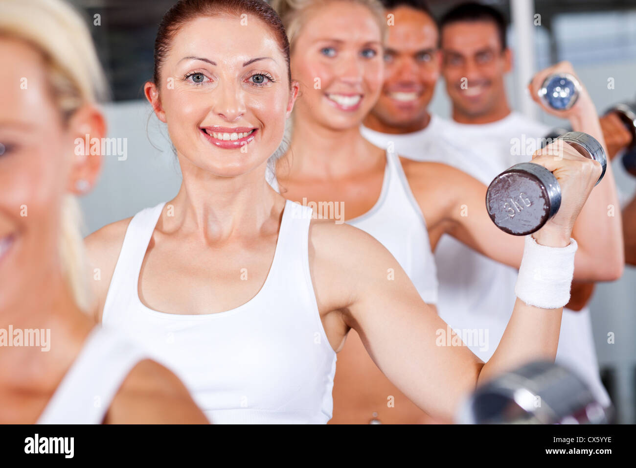 group of fitness people lifting weight in gym Stock Photo - Alamy