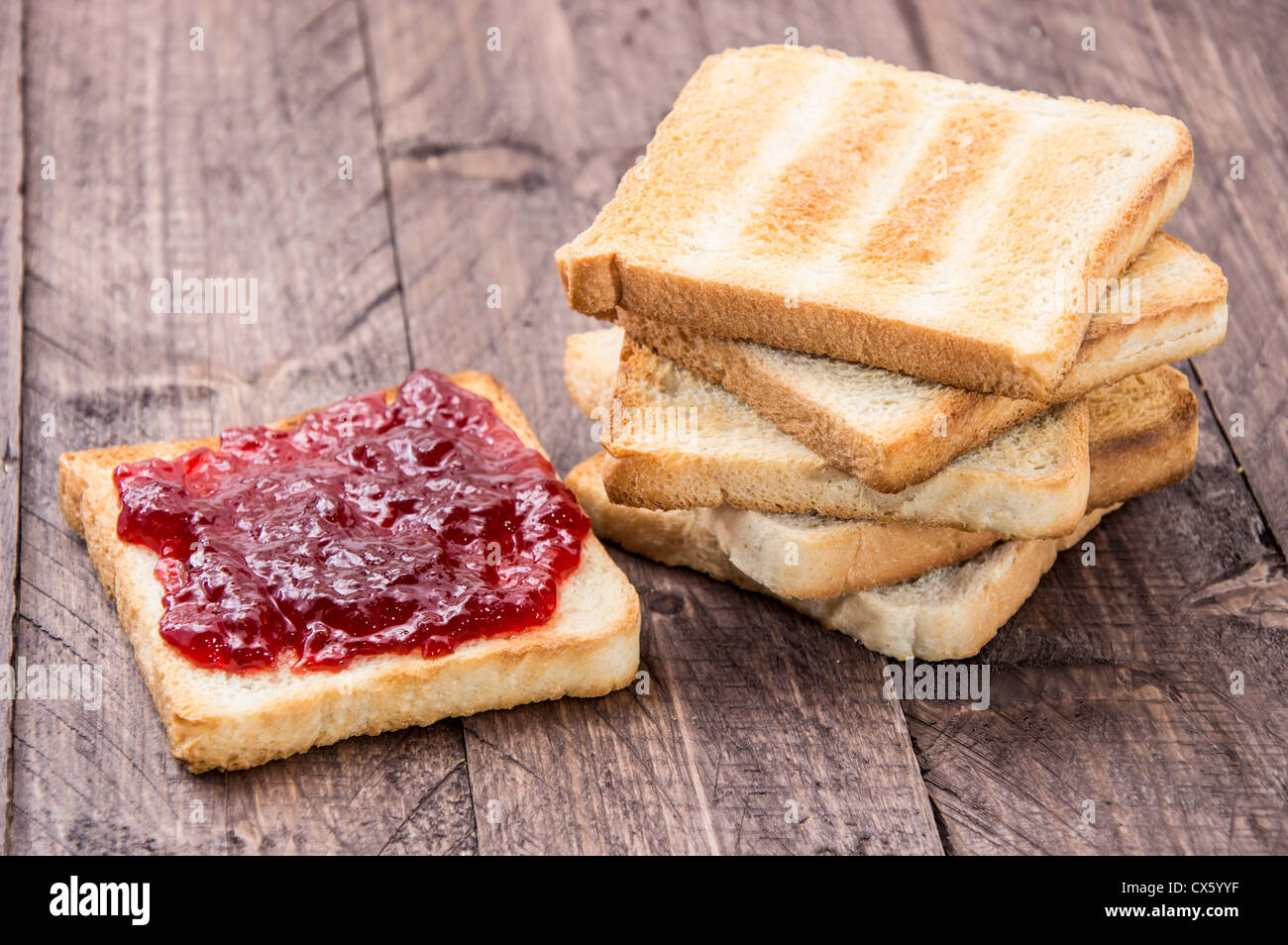 Jam on toast on wooden background Stock Photo - Alamy