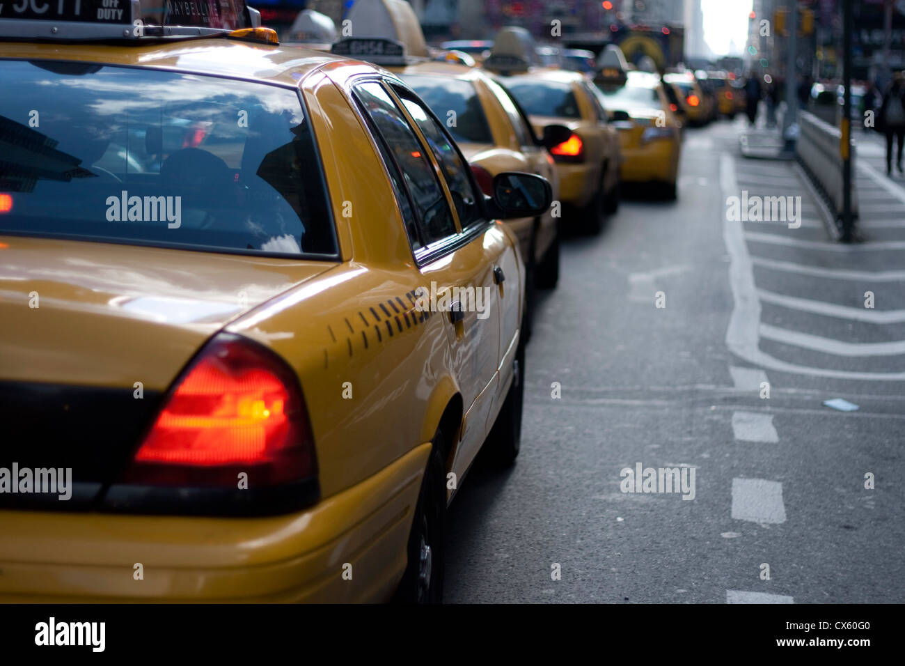 A queuing line of taxi cars waiting with red brake lights on Stock ...