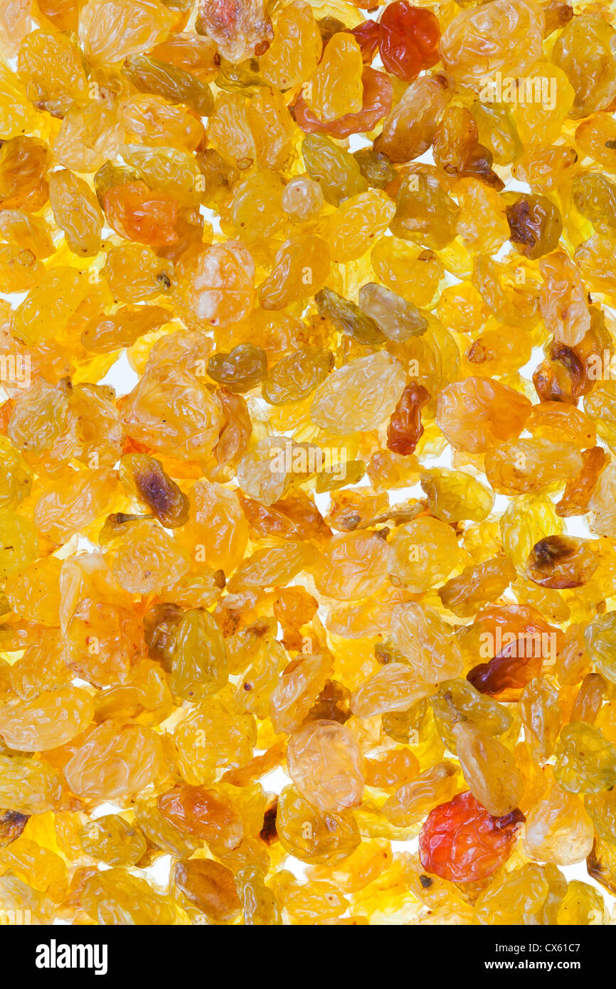 many sultana raisins close up on white background Stock Photo - Alamy