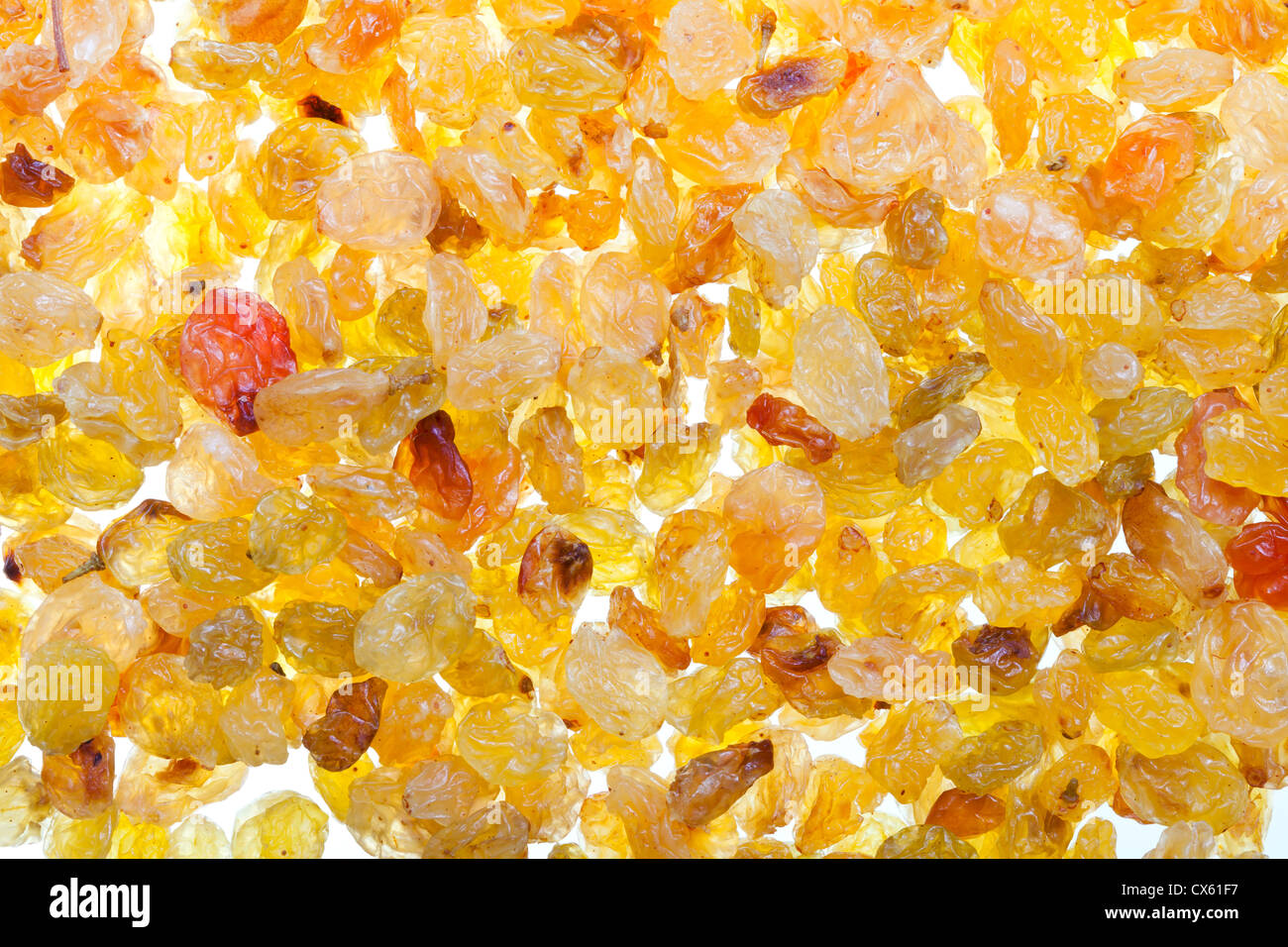 many sultana raisins close up on white background Stock Photo - Alamy