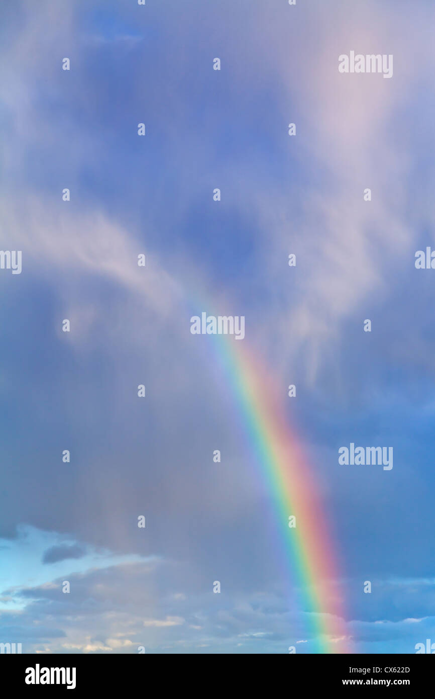 rainbow in autumn blue cloudy sky Stock Photo - Alamy