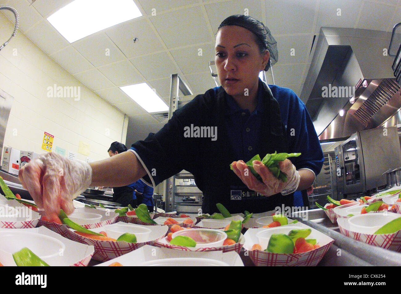 School lunch staff preparing the new menu of healthier foods at the ...