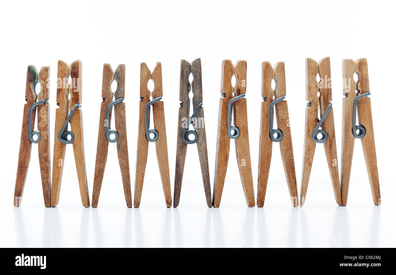 A bunch of clothes pins standing in front of a white background Stock ...