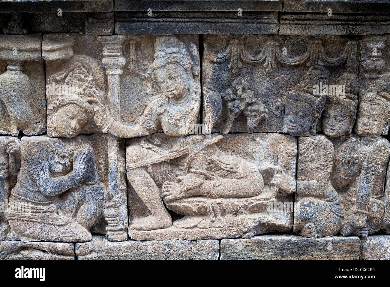 Wall Relief on the Buddhist temple Borobudur in Indonesia Stock Photo ...
