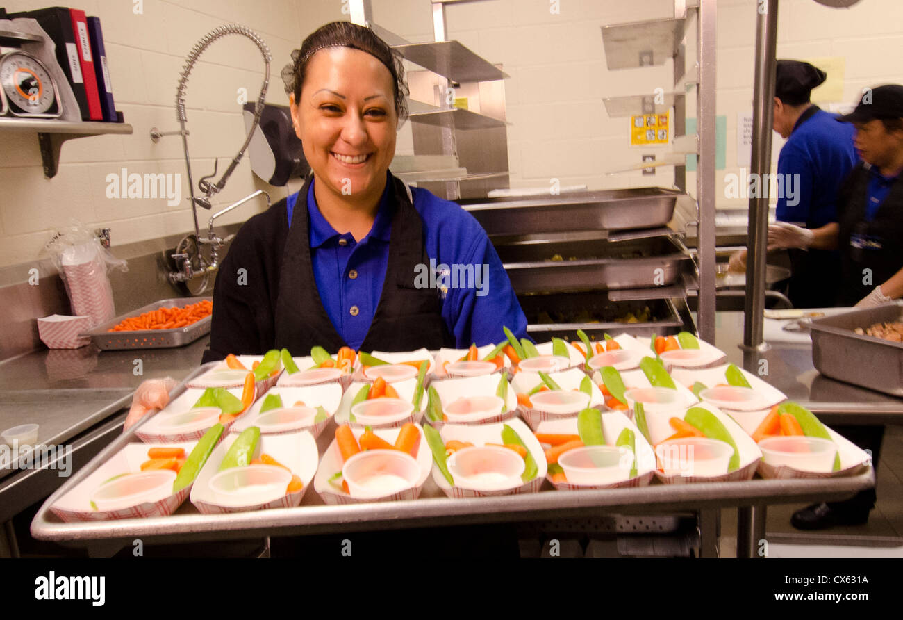 School lunch staff preparing the new menu of healthier foods at the ...