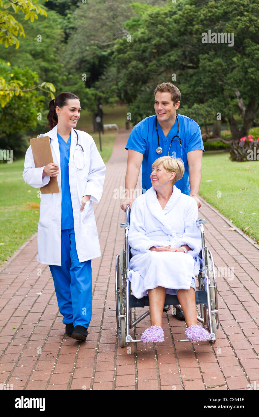 caring medical workers and senior patient outdoors Stock Photo - Alamy