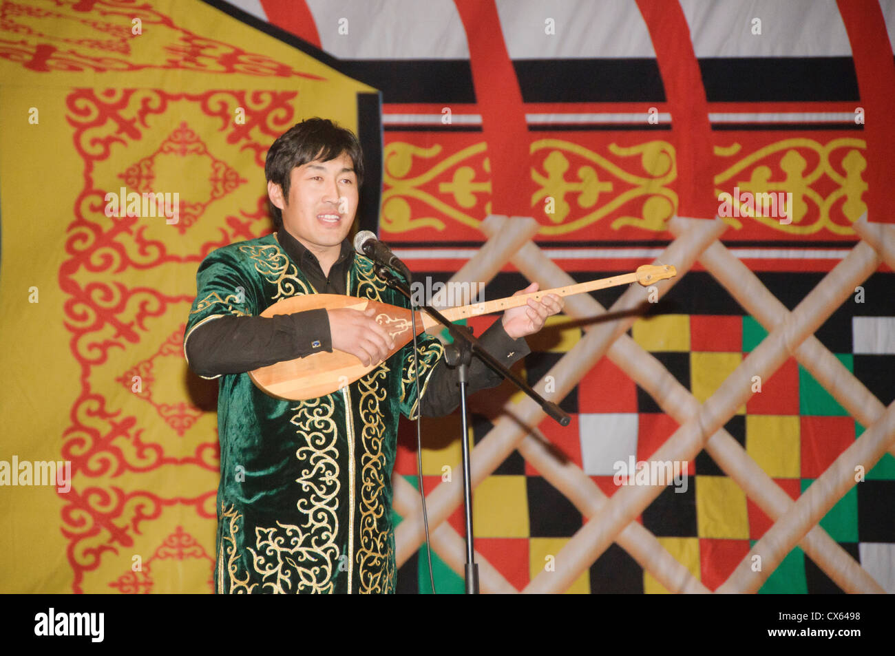 Kazakh musician playing a traditional dombra string instrument in Bayan ...