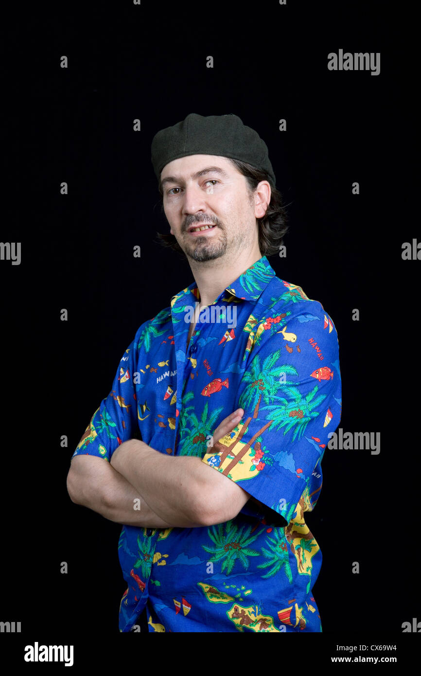 young happy man with a hawaiian shirt on black background Stock Photo ...