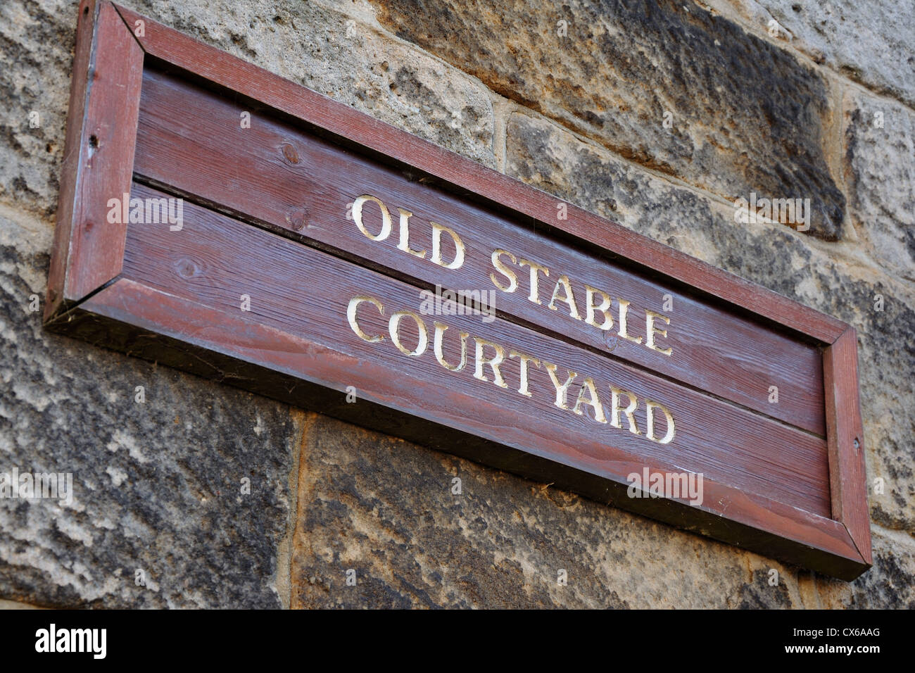 Sign on wall indicating old stable courtyard in Pollok Country Park ...
