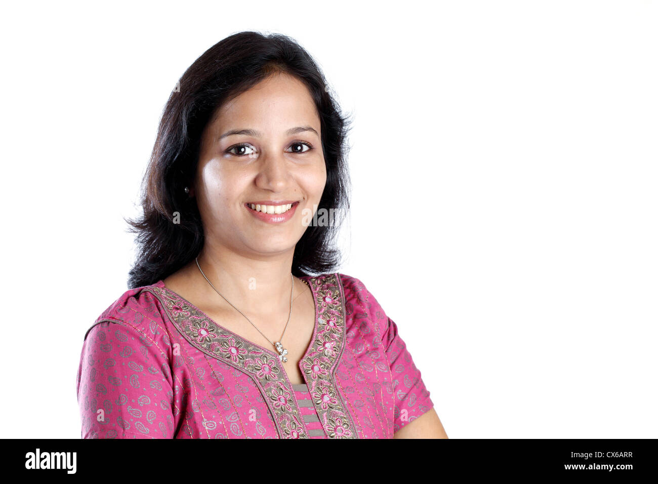 Smiling young Indian woman against white Stock Photo - Alamy