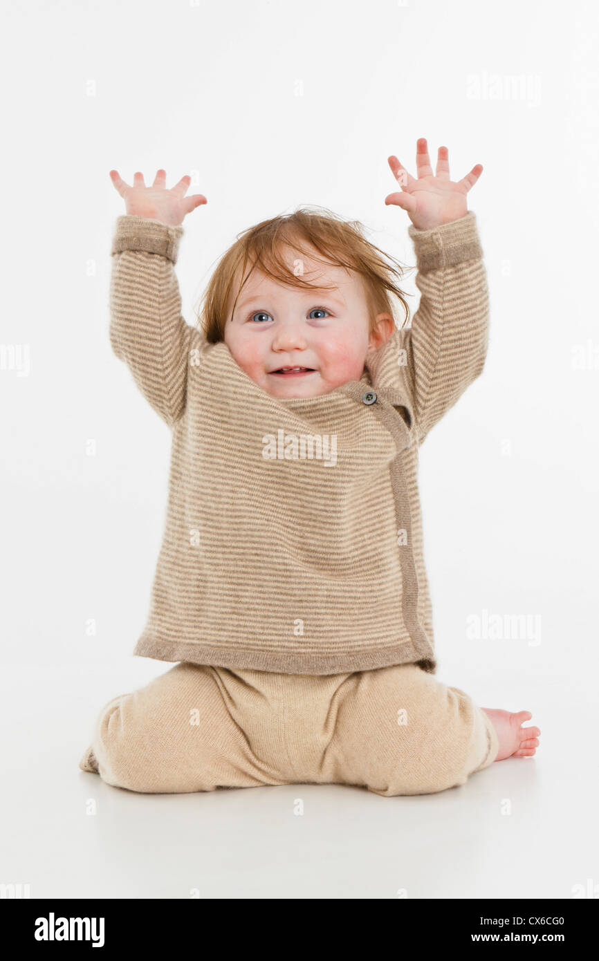 A baby girl with arms raised Stock Photo - Alamy