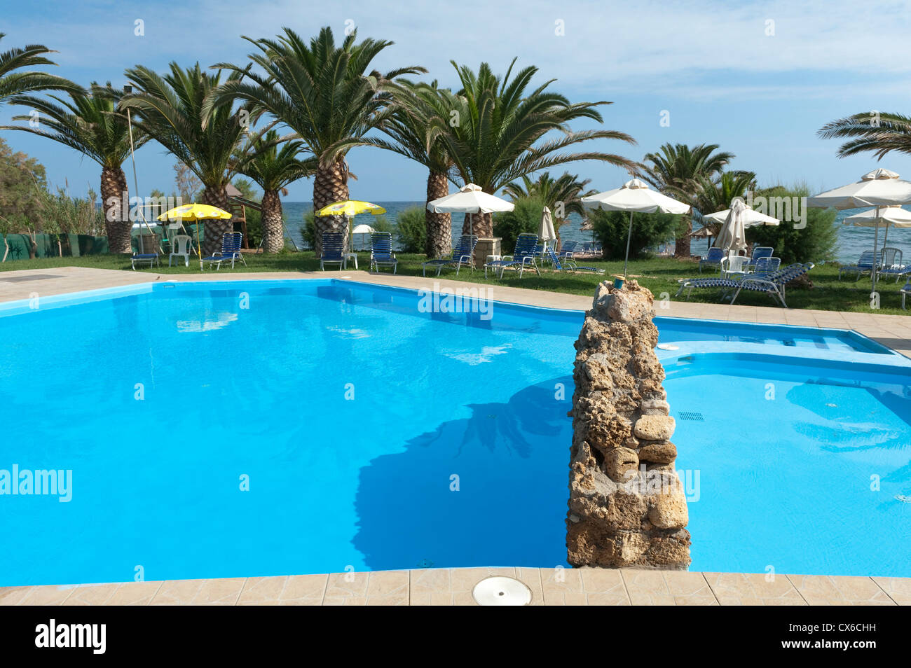 Hotel swimming pool with palm trees and sea, Crete Greece Stock Photo ...