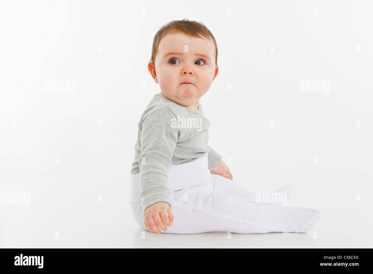 Portrait of a baby girl sitting Stock Photo - Alamy