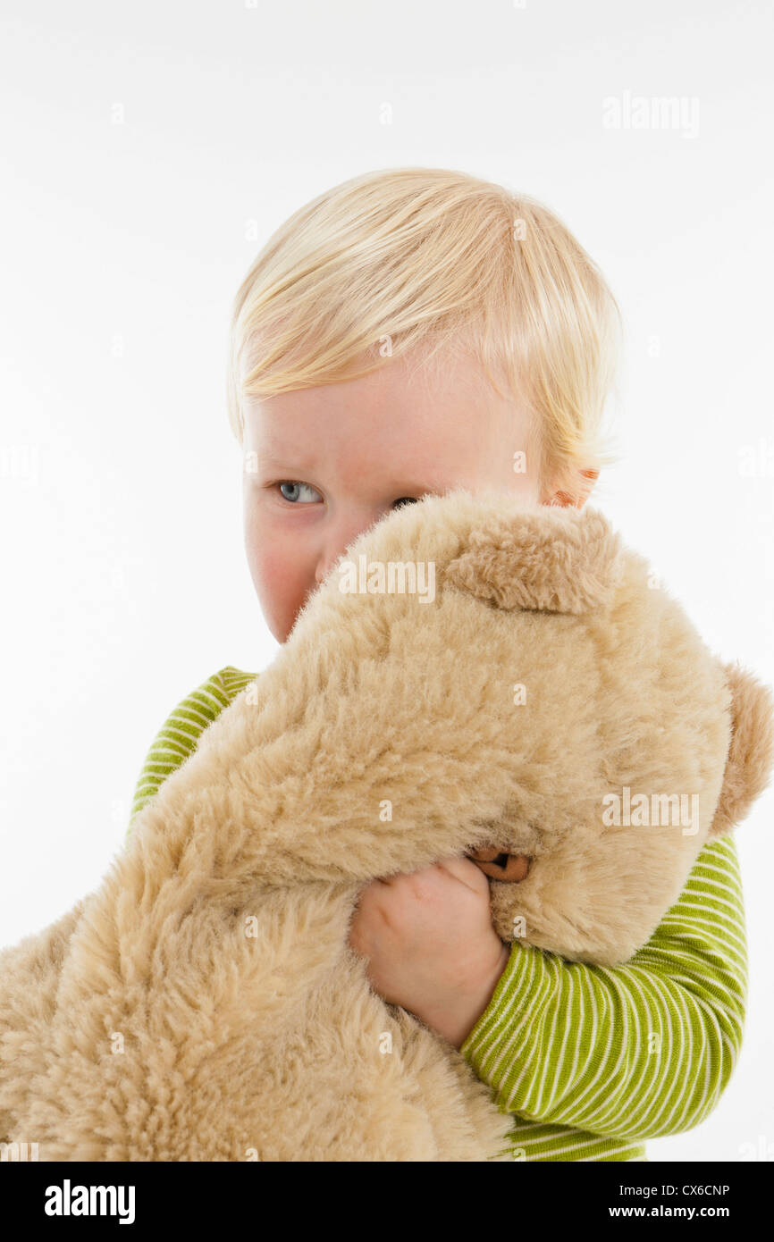 A toddler hugging a teddy bear Stock Photo - Alamy