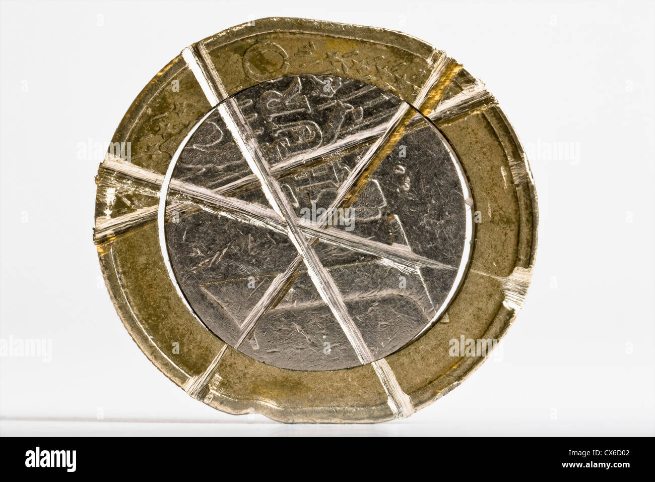 A one euro coin with crisscrossed dents in it Stock Photo - Alamy