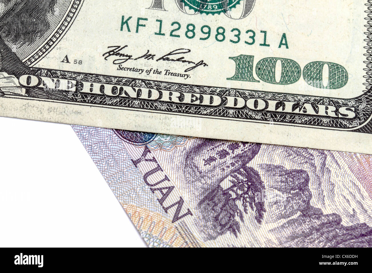 A close-up shot of a hundred dollar bill, alongside a chinese yuan ...