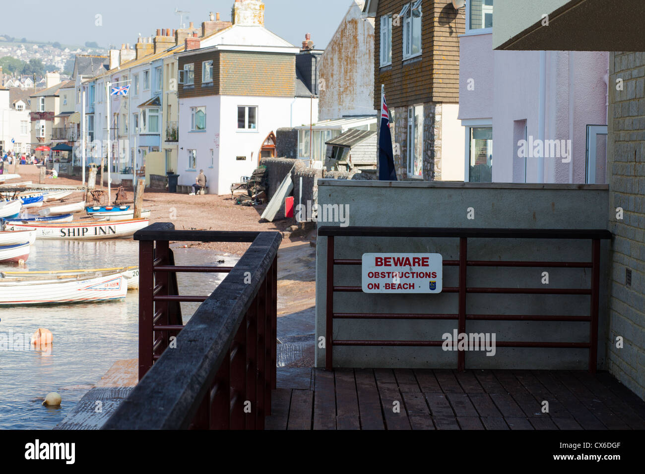 Sign "Beware Obstructions on beach" and steps to the beach in the ...