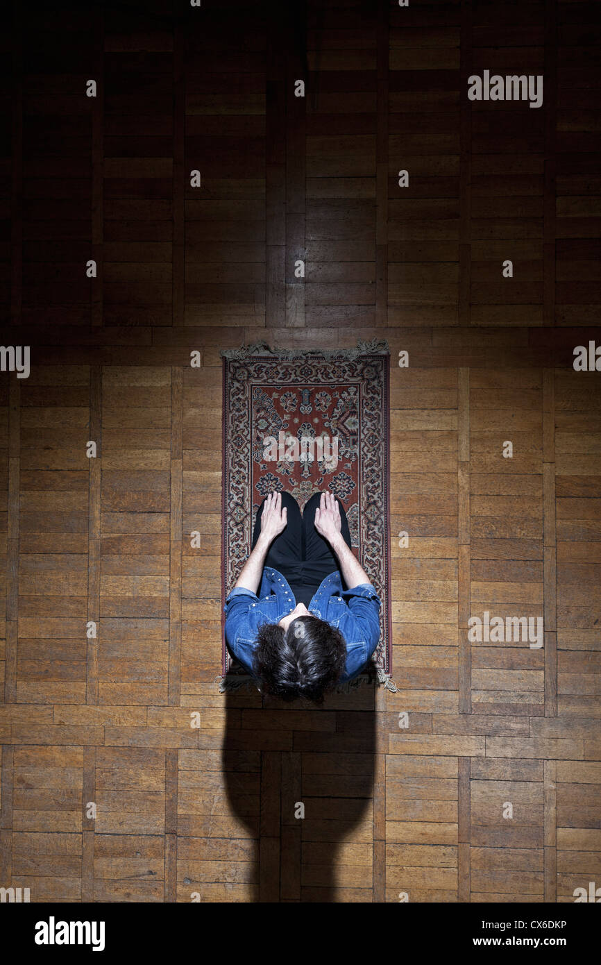 Muslim man on prayer mat hi-res stock photography and images - Alamy