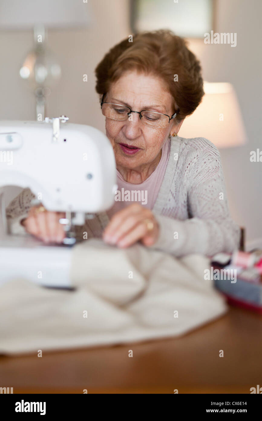 A senior woman sewing Stock Photo - Alamy