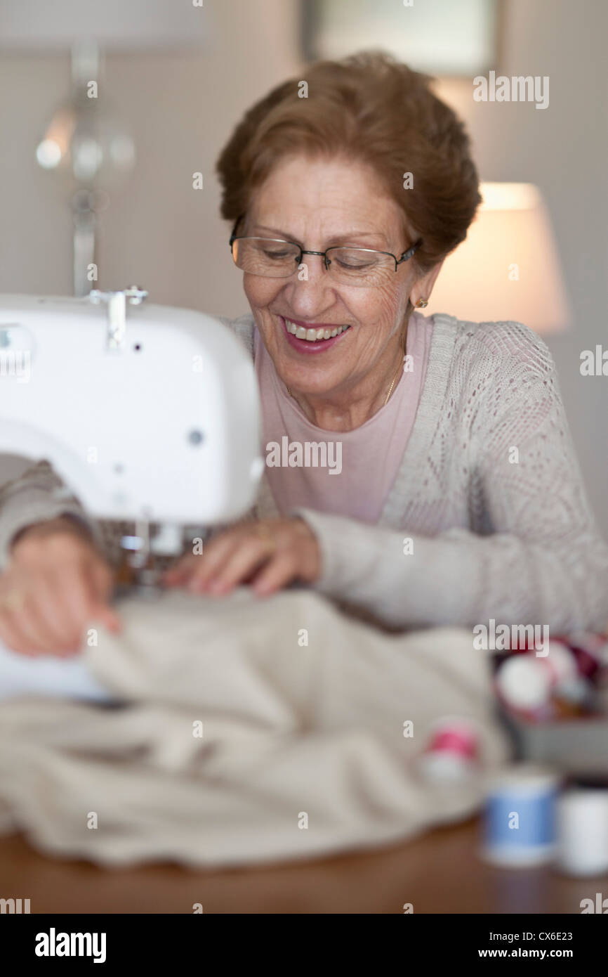 A senior woman sewing Stock Photo - Alamy