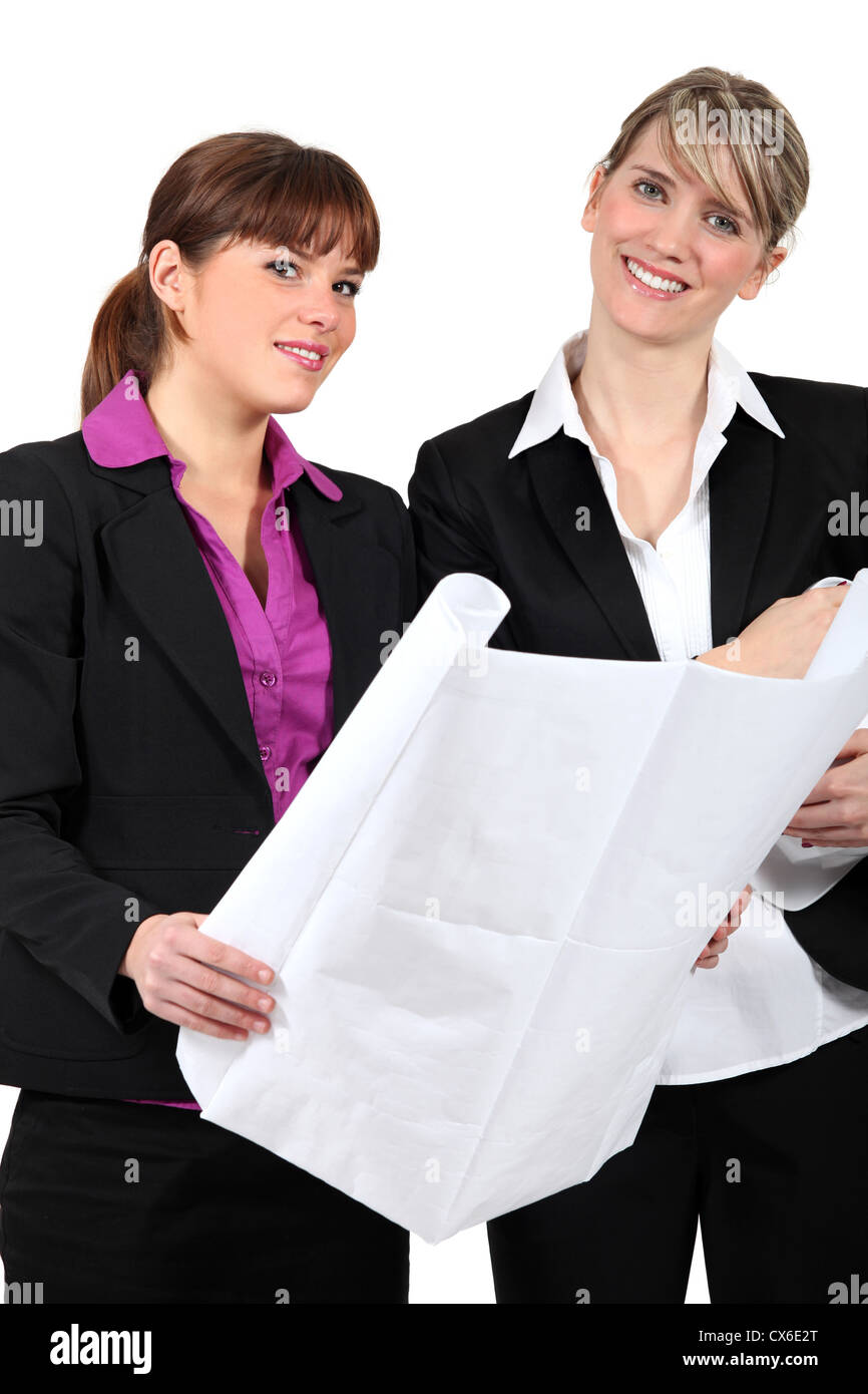 Two women holding plans Stock Photo - Alamy