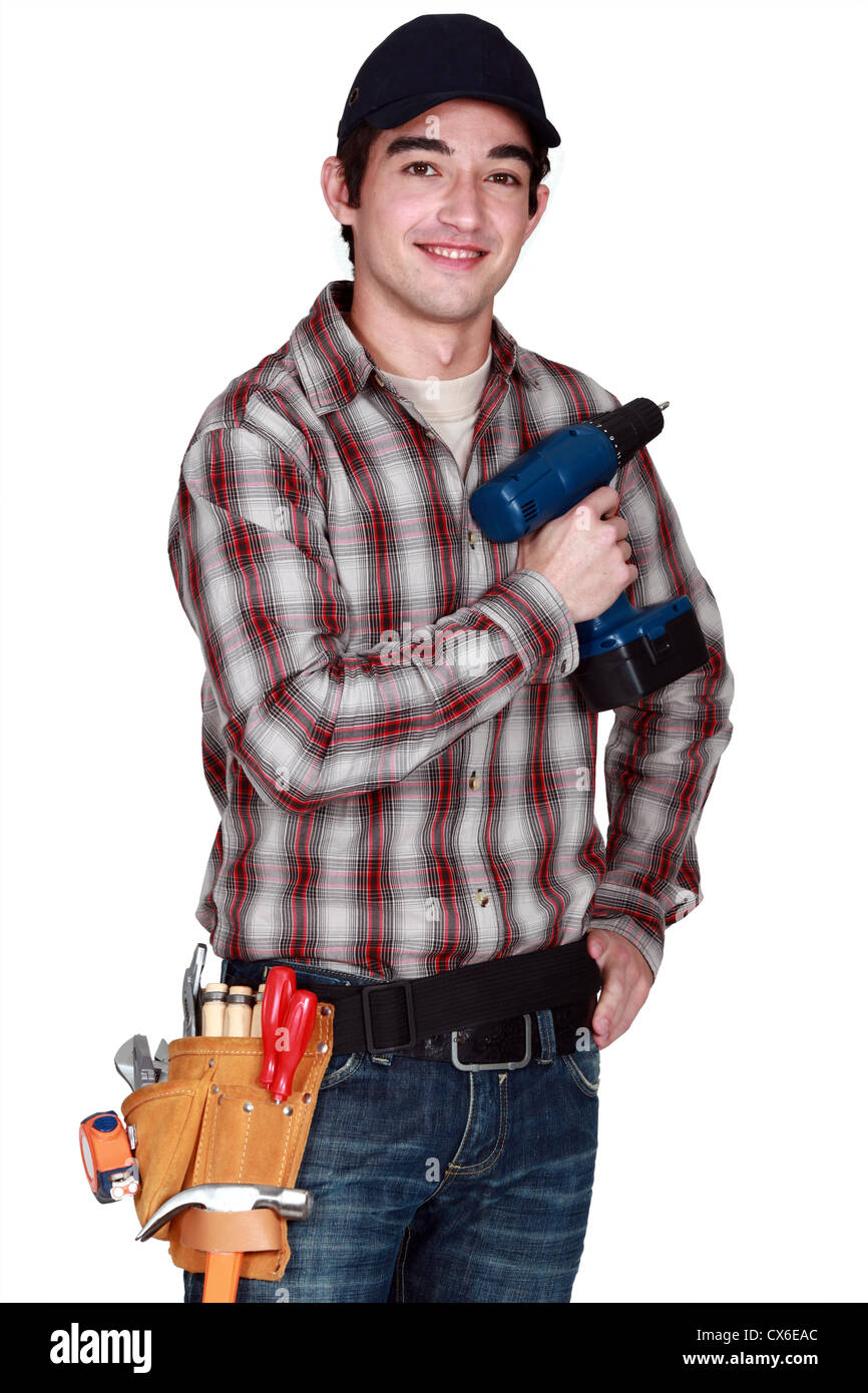 Young man with drill in hand Stock Photo - Alamy