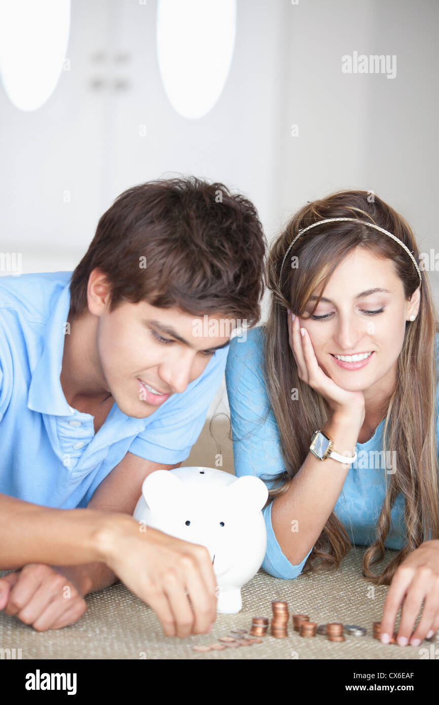 A young cheerful couple counting coins on the floor Stock Photo - Alamy