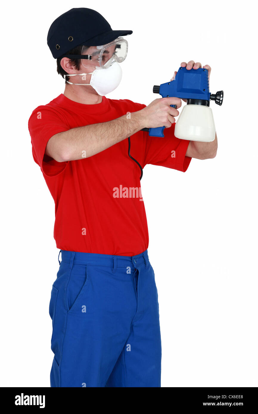 Man holding a paint sprayer Stock Photo - Alamy