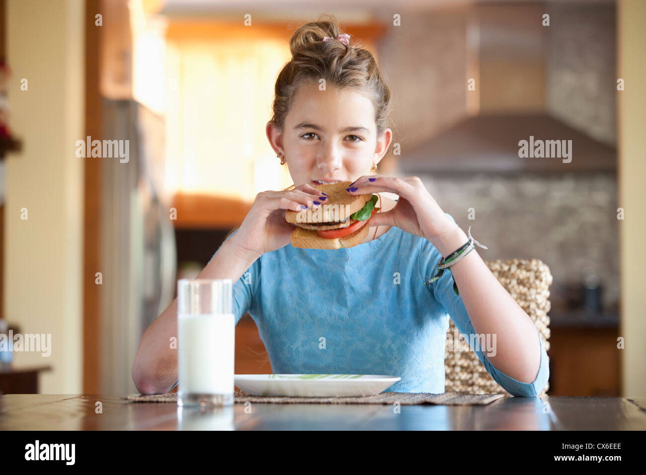 Girl eating sandwich Stock Photo - Alamy