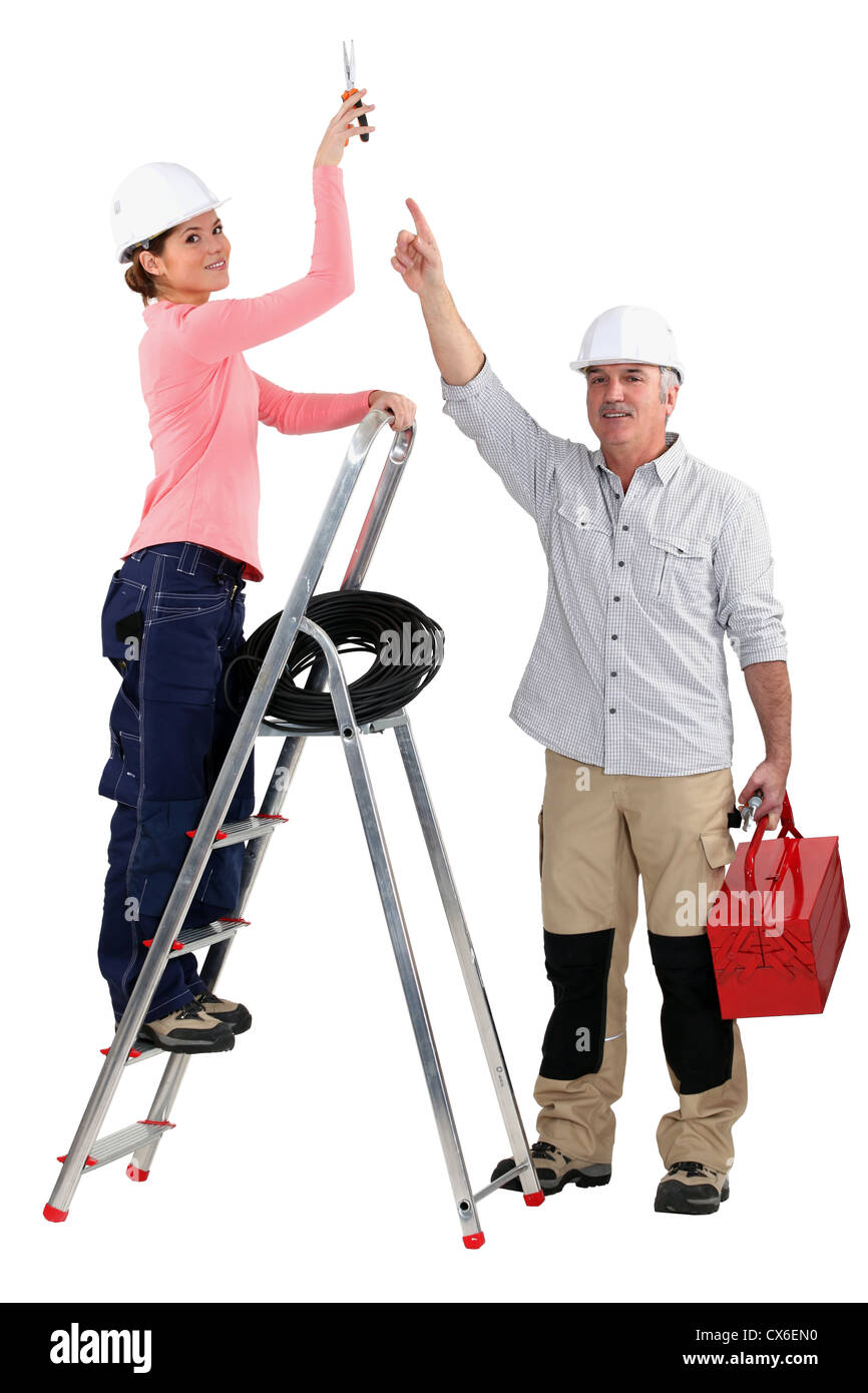 Experienced tradesman pointing to his assistant Stock Photo - Alamy