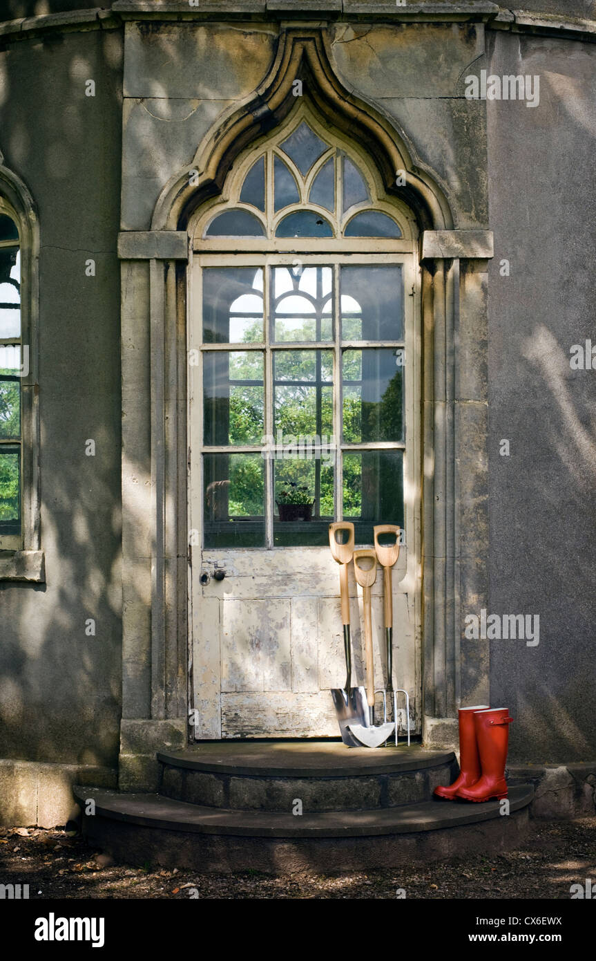 Garden tools and Wellington boots on doorstep Stock Photo - Alamy