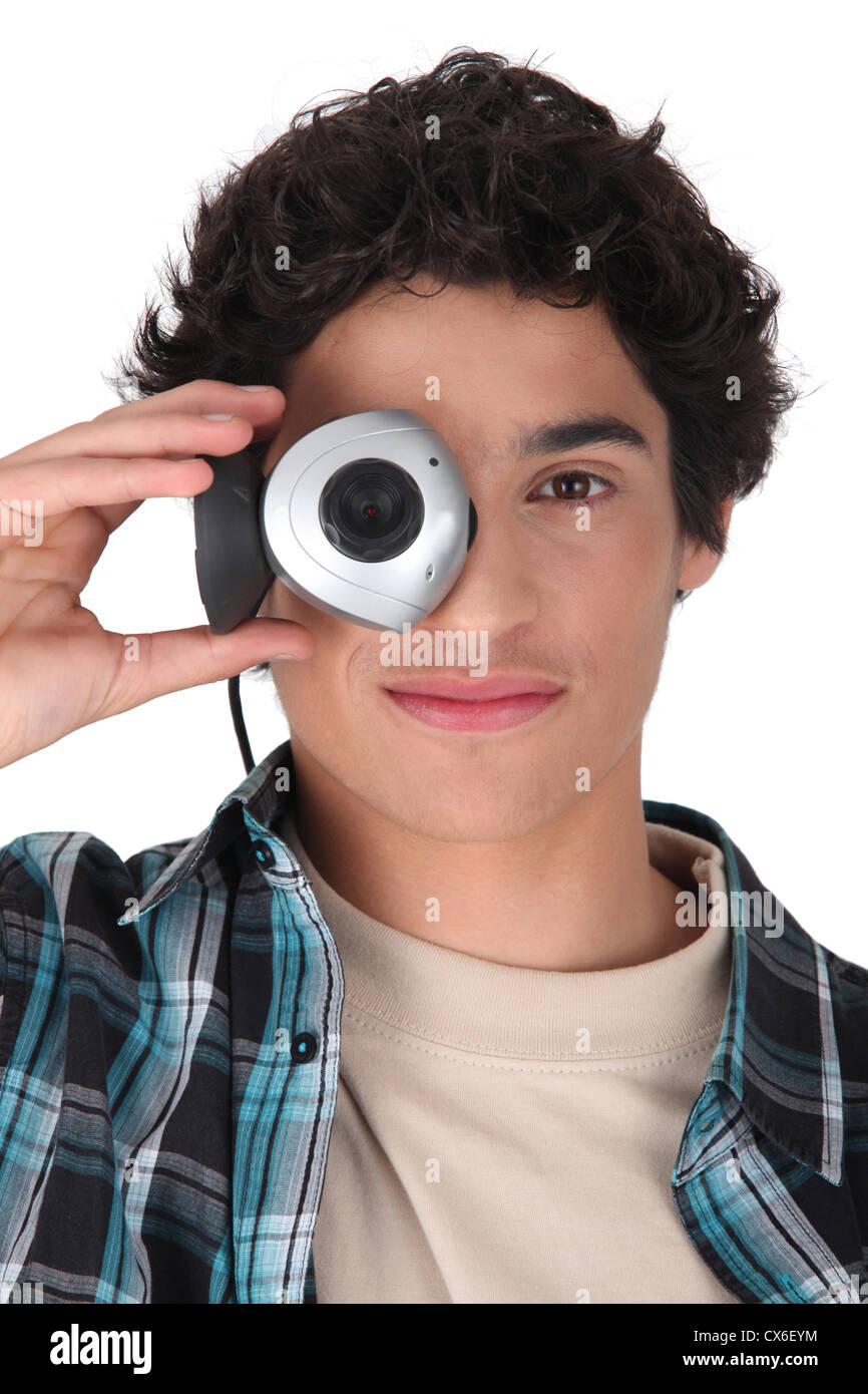 Young man hiding his eye with webcam Stock Photo - Alamy