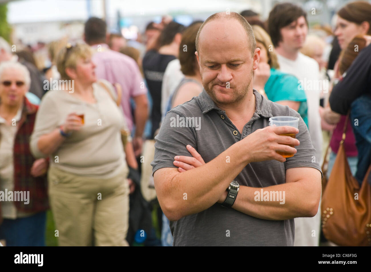 Man drinking beer in crowd at Ludlow Food Festival 2012 Ludlow ...