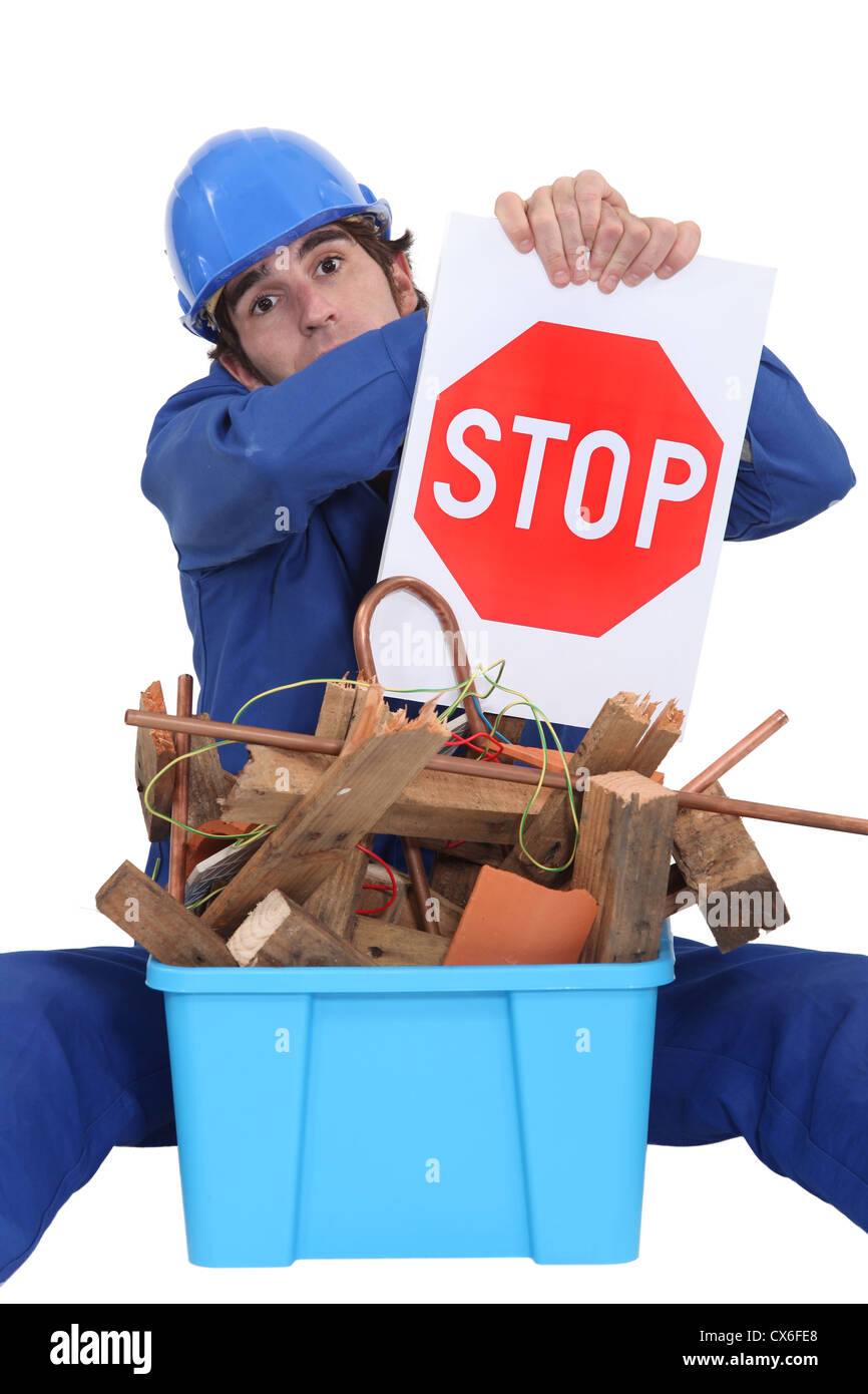 Builder suggesting people stop wasting materials Stock Photo - Alamy