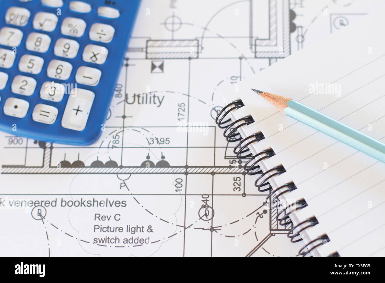 Calculator,Pad And Pencil Resting On House Plans Stock Photo - Alamy