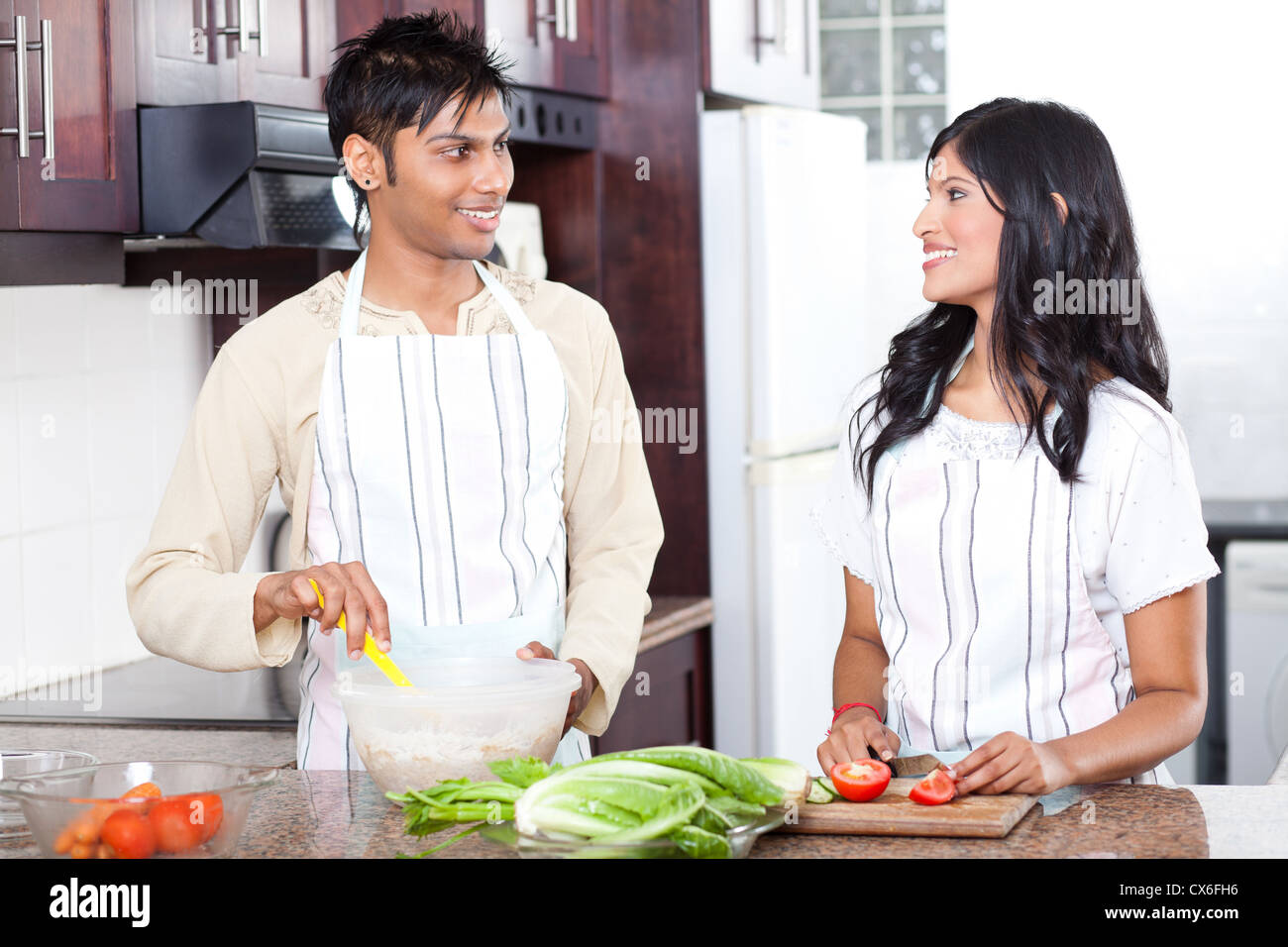 young Indian couple cooking in modern kitchen Stock Photo - Alamy