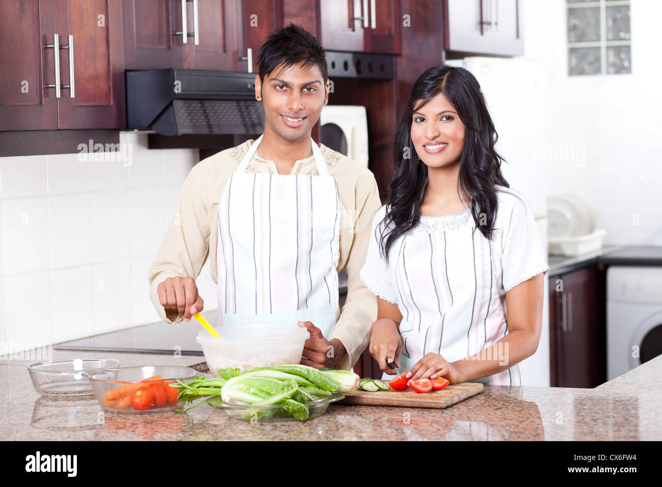young Indian couple cooking in kitchen Stock Photo - Alamy