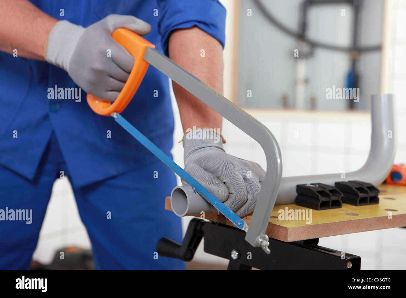 craftsman cutting a plastic pipe Stock Photo - Alamy