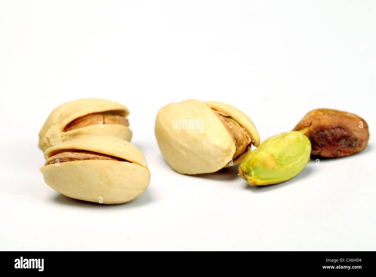 Roasted pistachios spilled on white background Stock Photo - Alamy