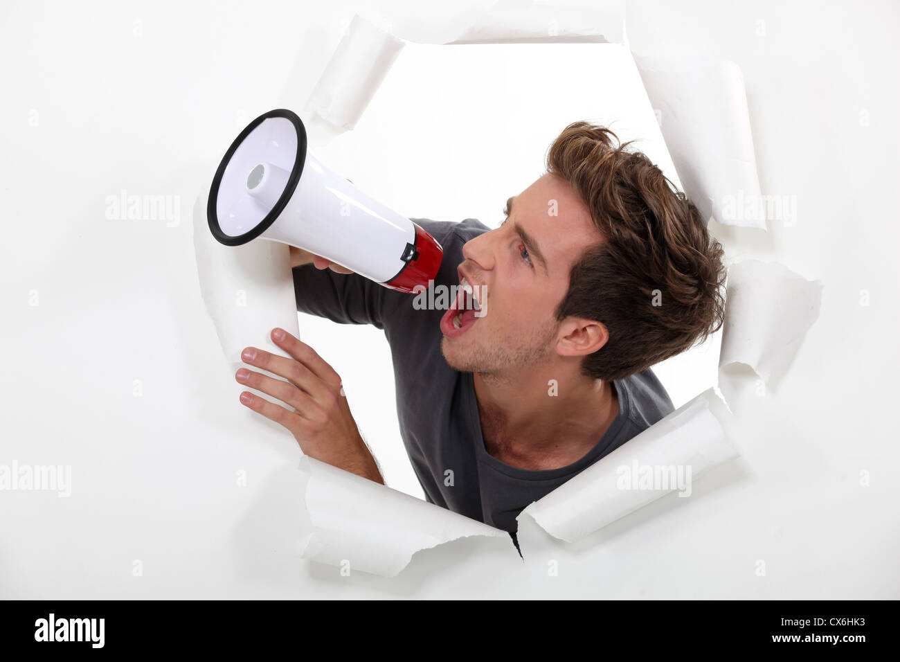 Young man shouting into a megaphone Stock Photo - Alamy