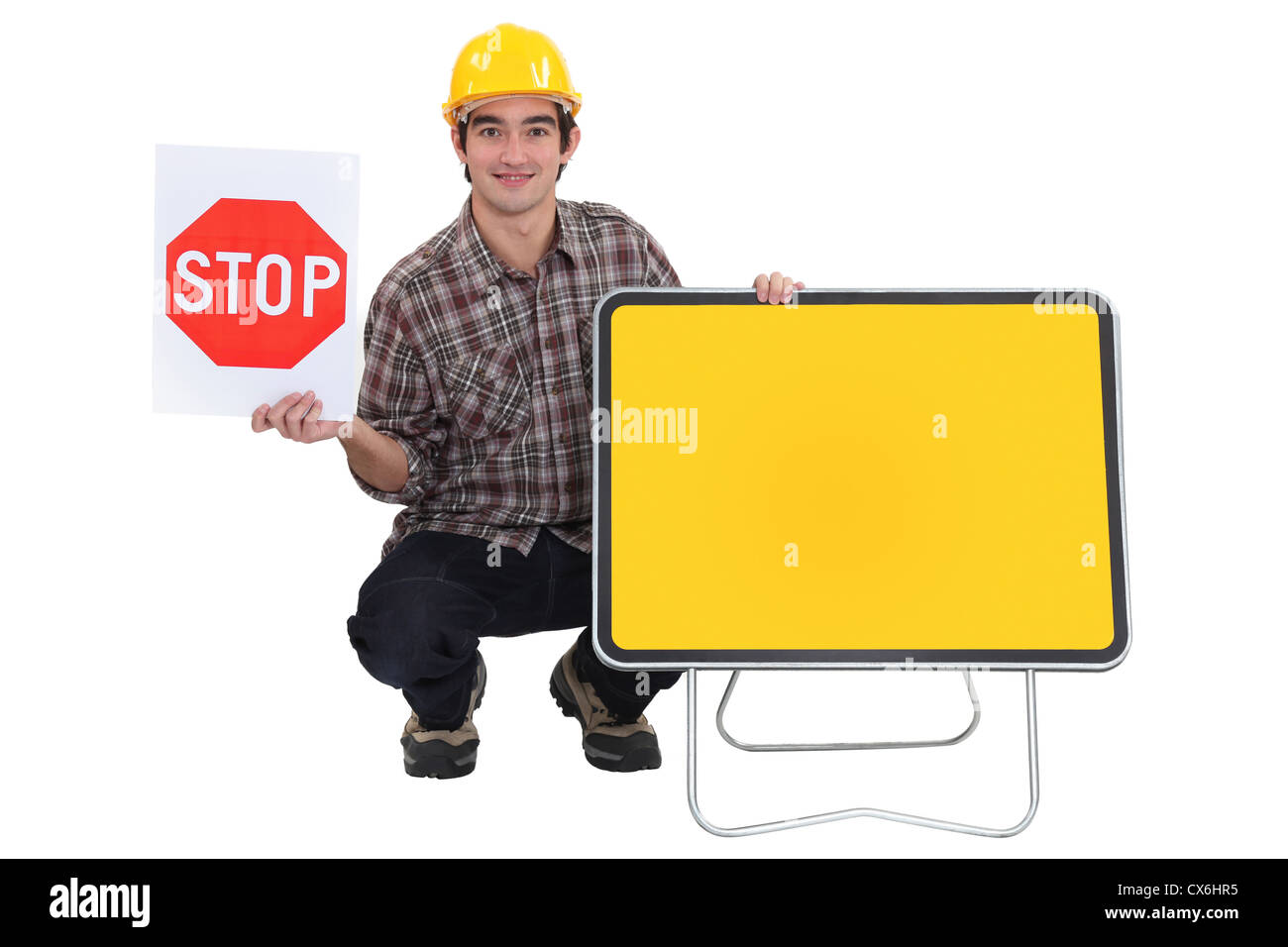 Worker with a blank road sign Stock Photo - Alamy